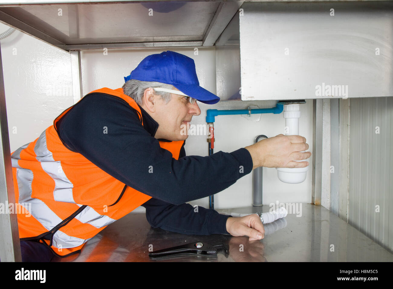 plumber at work in a building site Stock Photo - Alamy