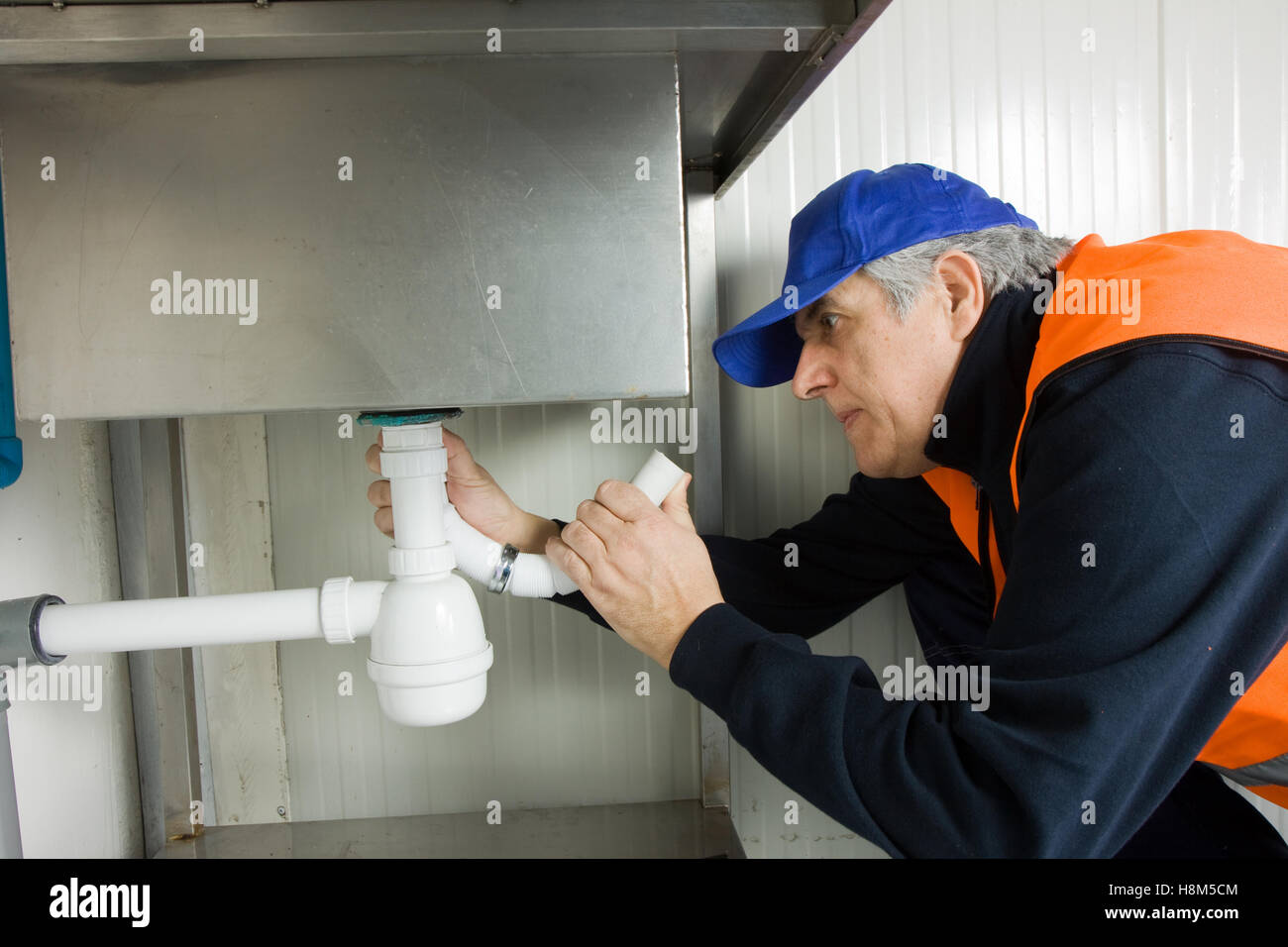 plumber at work in a building site Stock Photo - Alamy