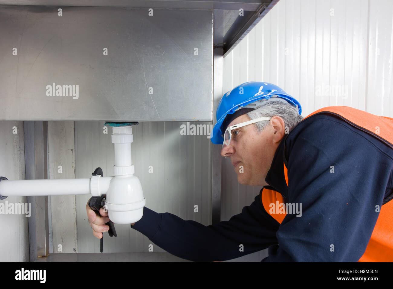 plumber at work in a building site Stock Photo - Alamy