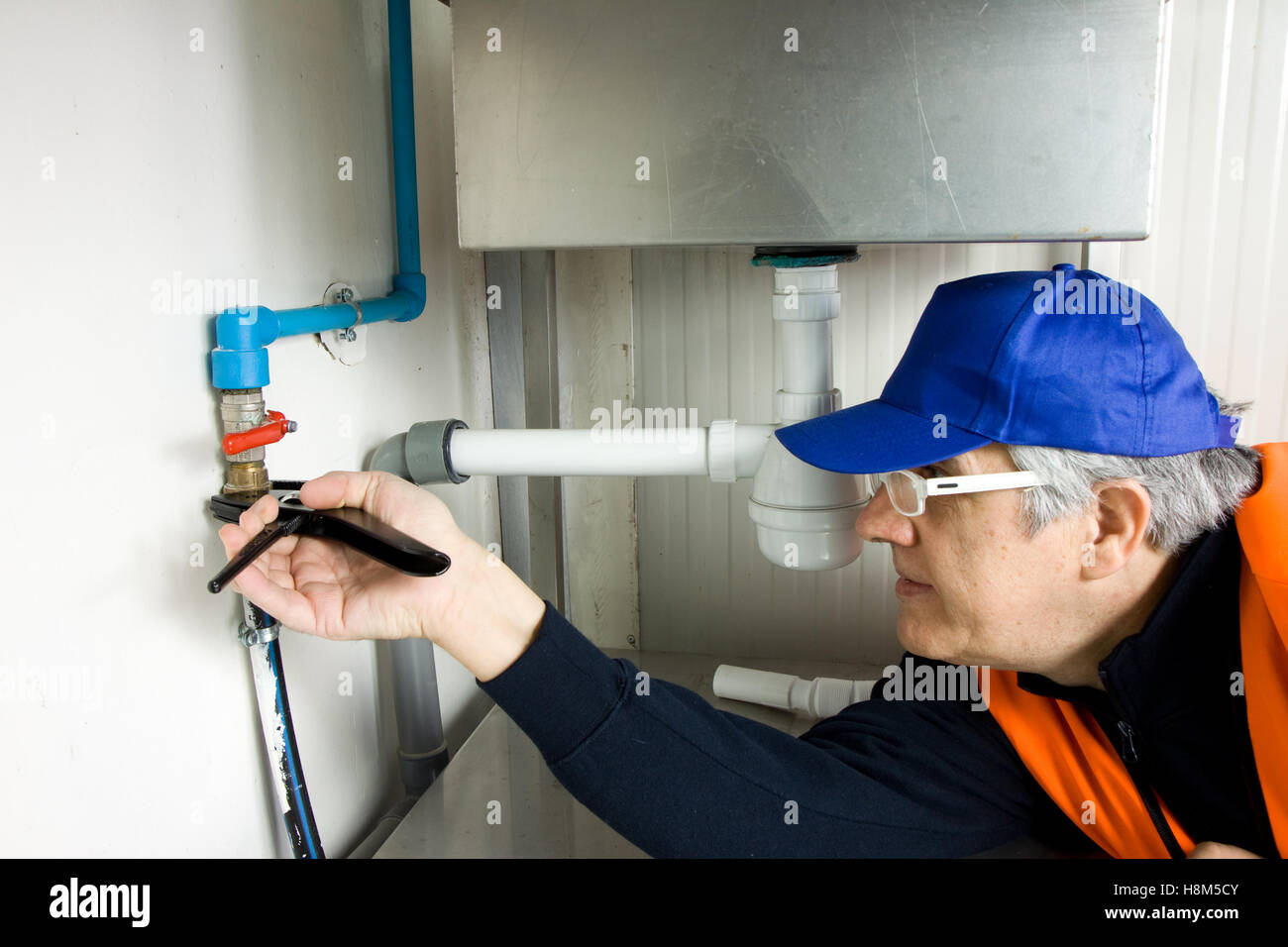 plumber at work in a building site Stock Photo - Alamy