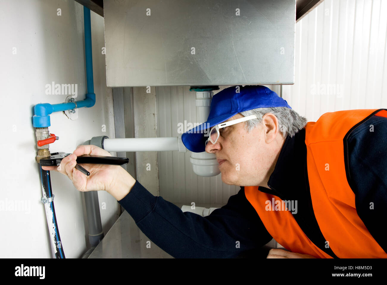 plumber at work in a building site Stock Photo - Alamy