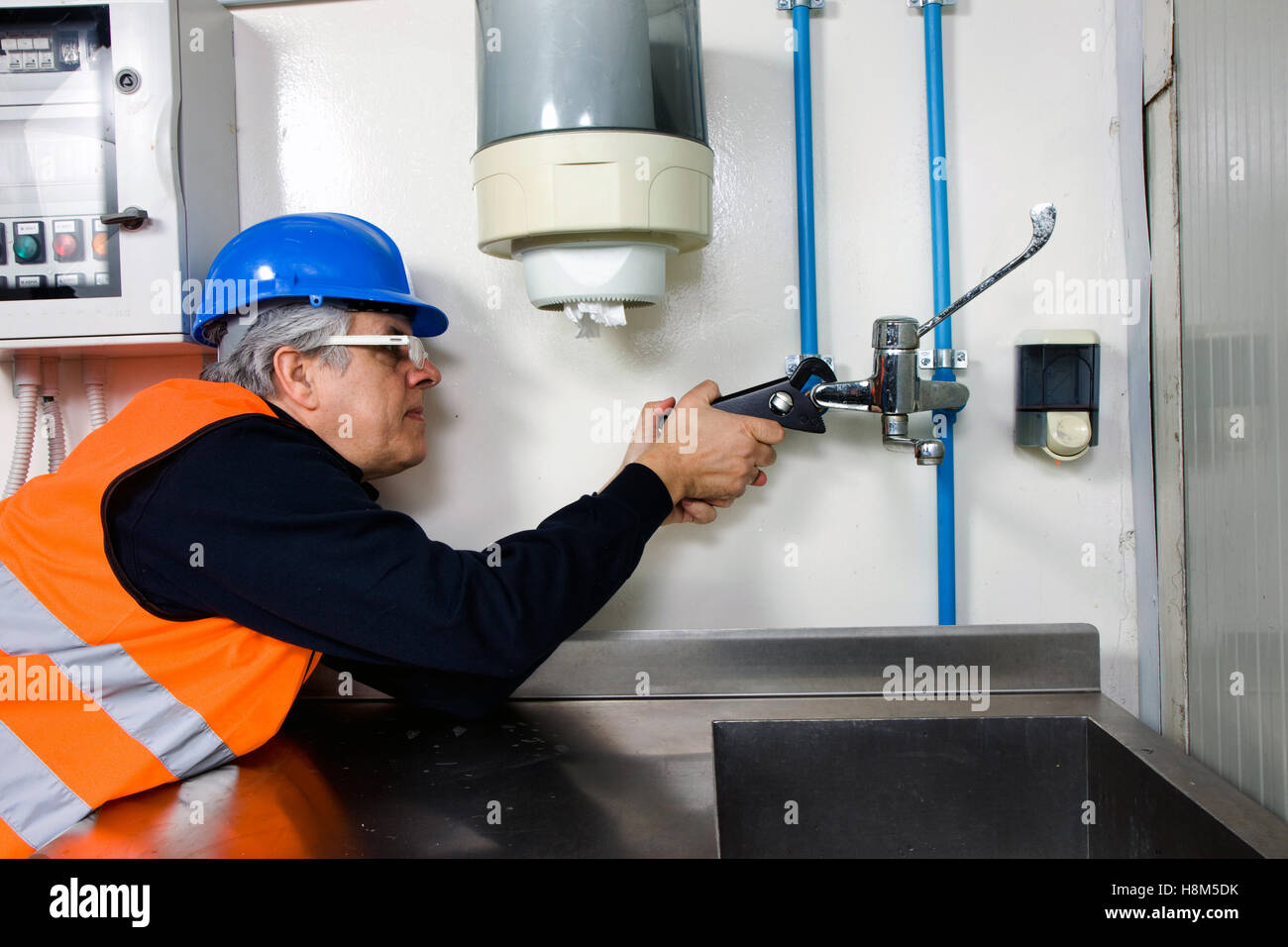 plumber at work in a building site Stock Photo - Alamy