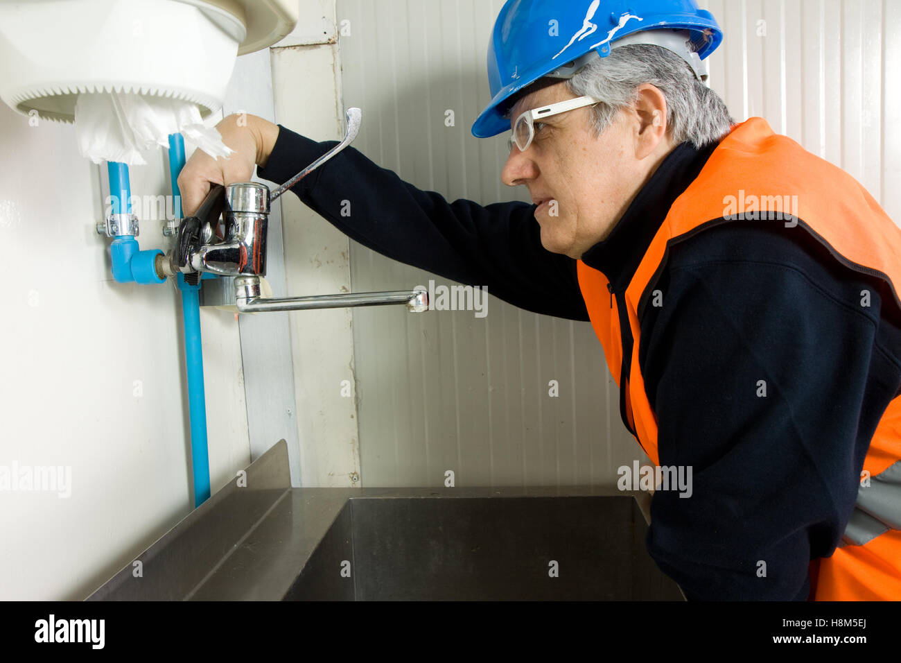 plumber at work in a building site Stock Photo - Alamy