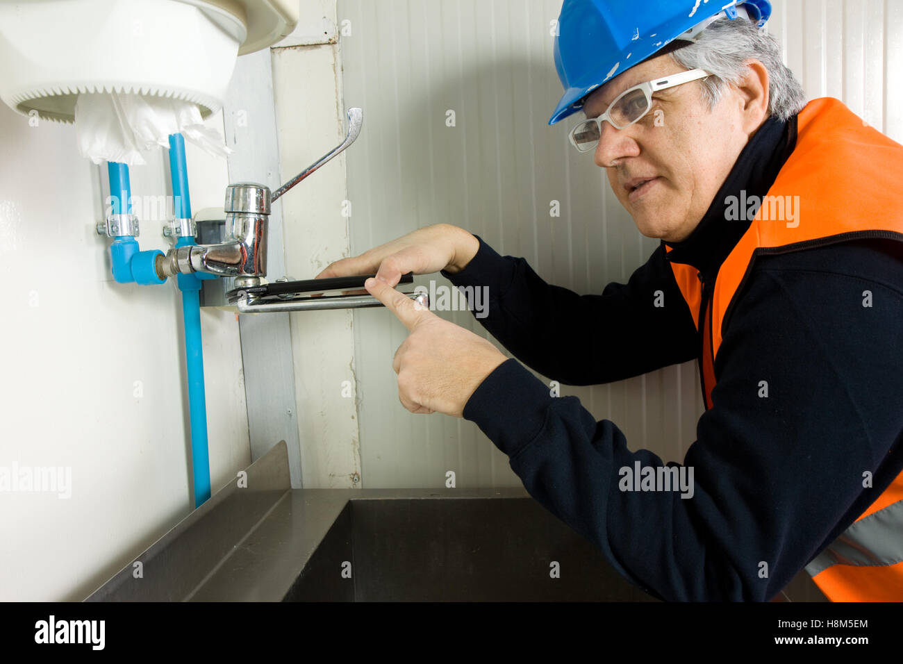 plumber at work in a building site Stock Photo - Alamy