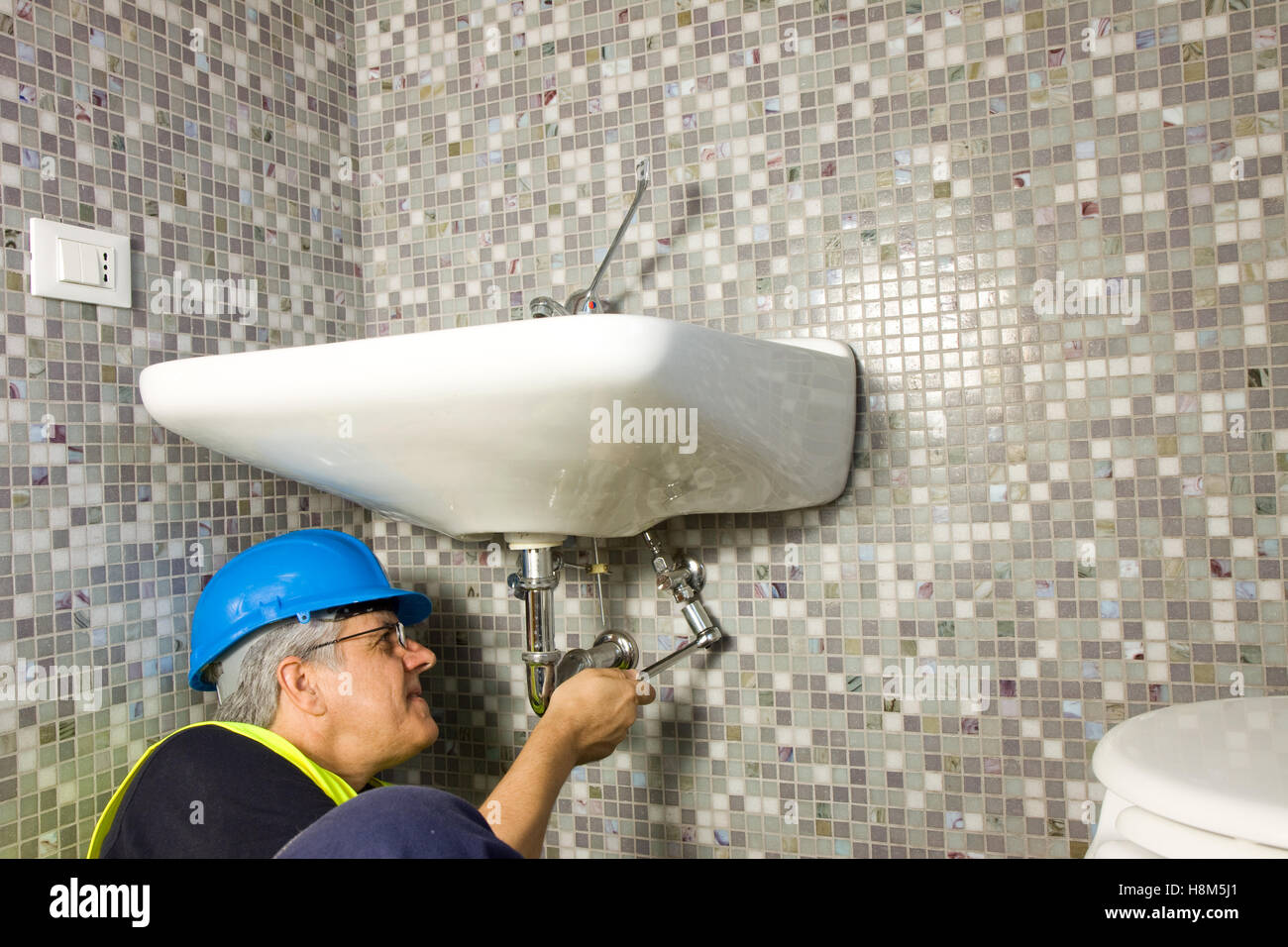 plumber at work in a building site Stock Photo - Alamy