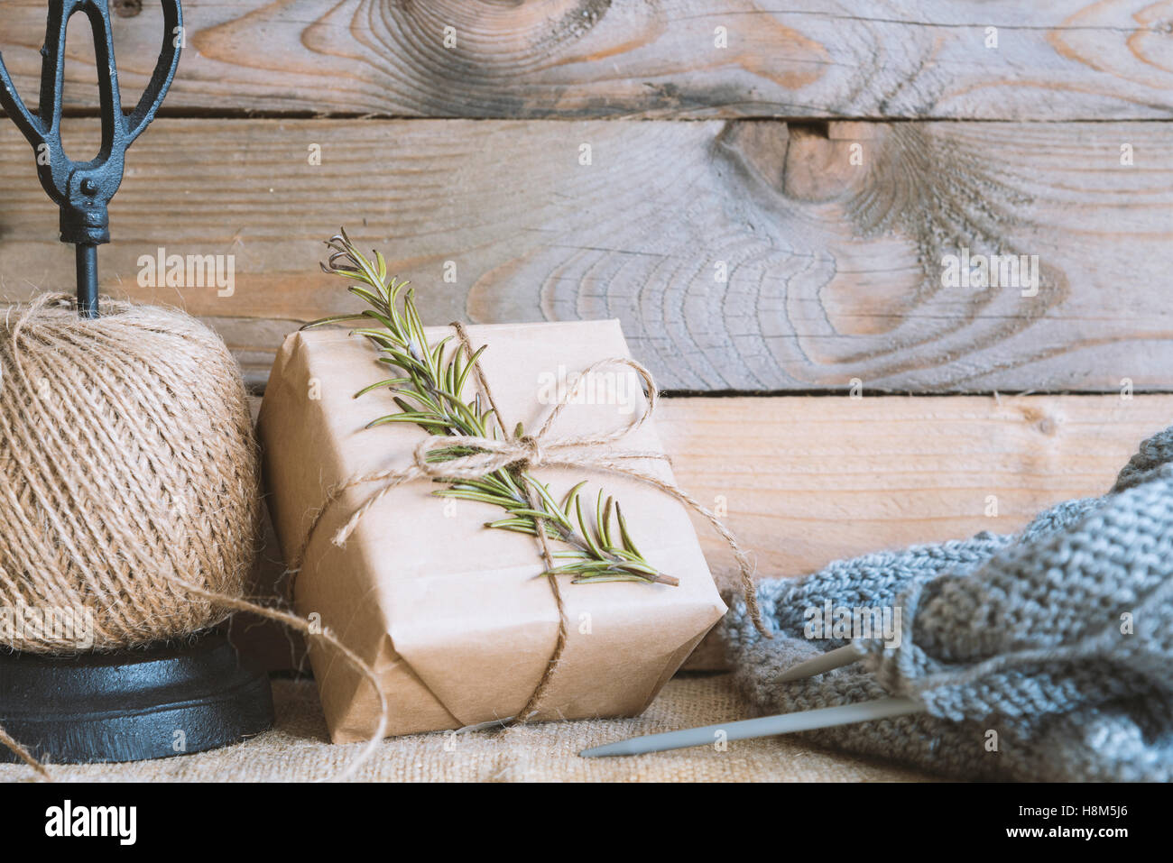 Rustic gift wrapping scene with knitting and gift wrapped in paper ...