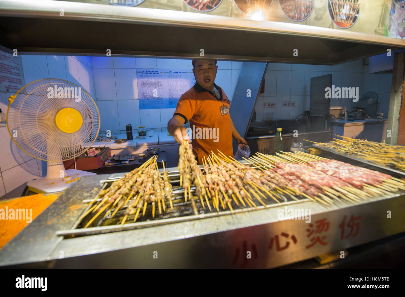 Beijing, China - Chef cooking meat on sticks in the Donghuamen Snack ...