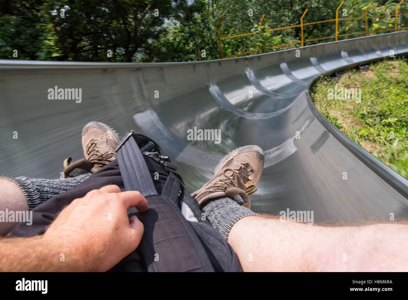 Mutianyu, China - Tourist sliding down the Toboggan slide at the Great ...