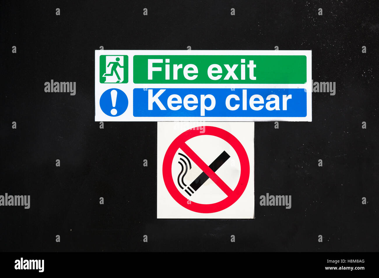 Fire Exit, Keep Clear and No Smoking signs all affixed to a door Stock ...