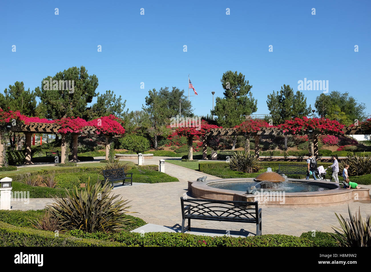 A family walks past the fountain in the Formal Garden at Bill Barber ...