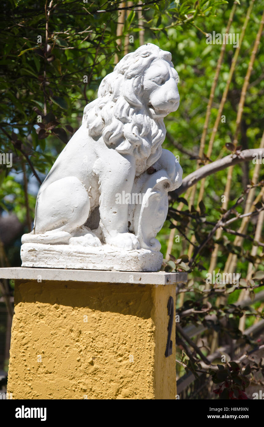 White decorative lion sculpture near house, Greece Stock Photo - Alamy