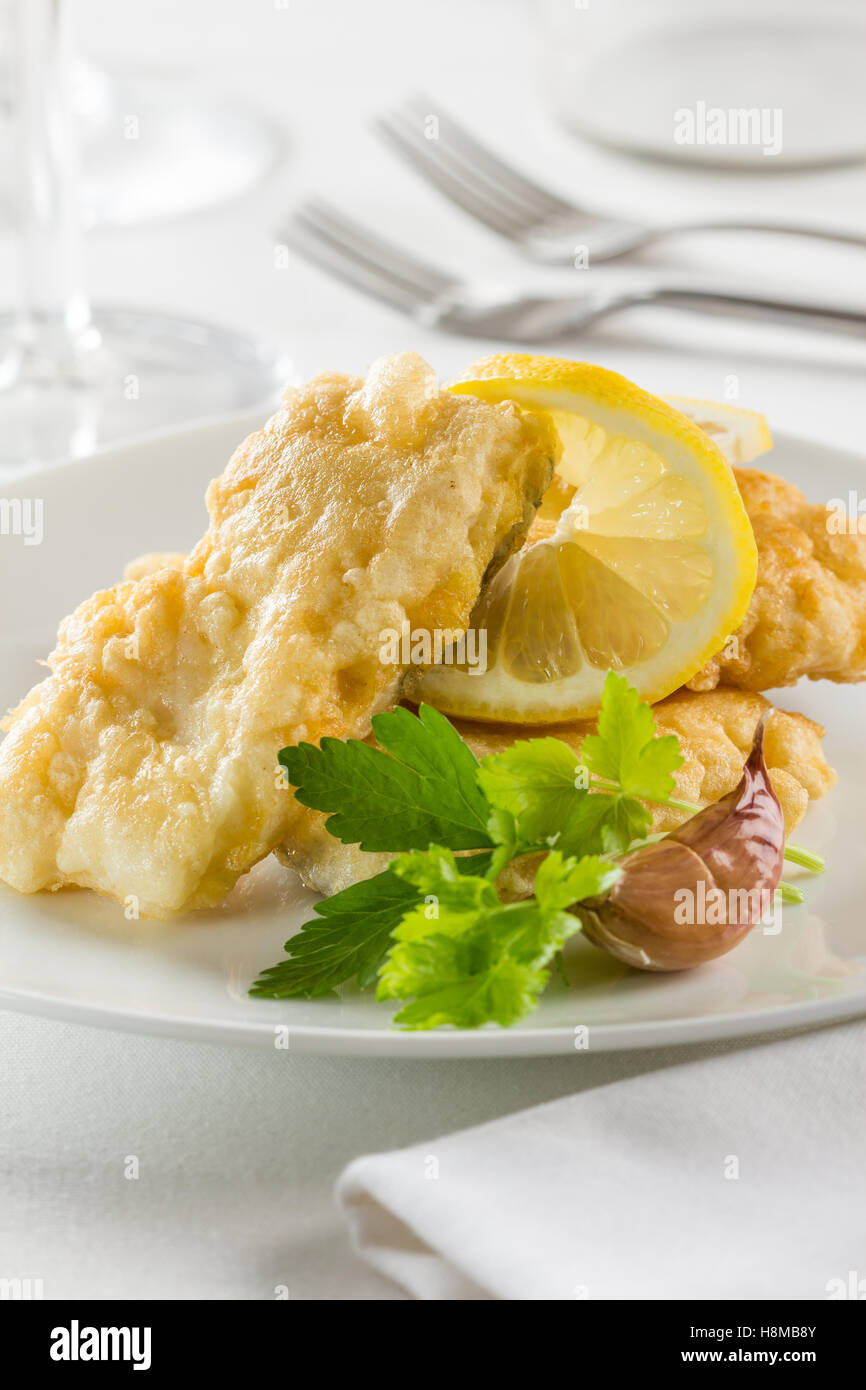 Battered hake fillets with parsley, lemon and garlic Stock Photo - Alamy