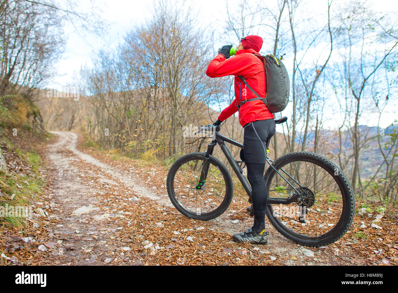 Man mountain biking rest and drink from the bottle before you make the ...