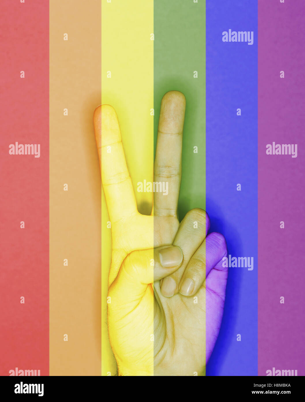 Hand making Peace sign over Rainbow flag Stock Photo - Alamy