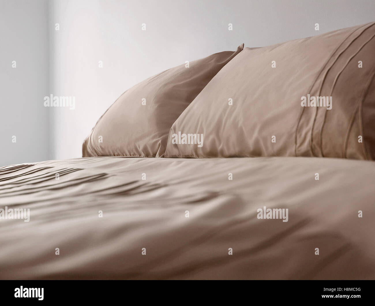 Brown bedding on bed Stock Photo - Alamy
