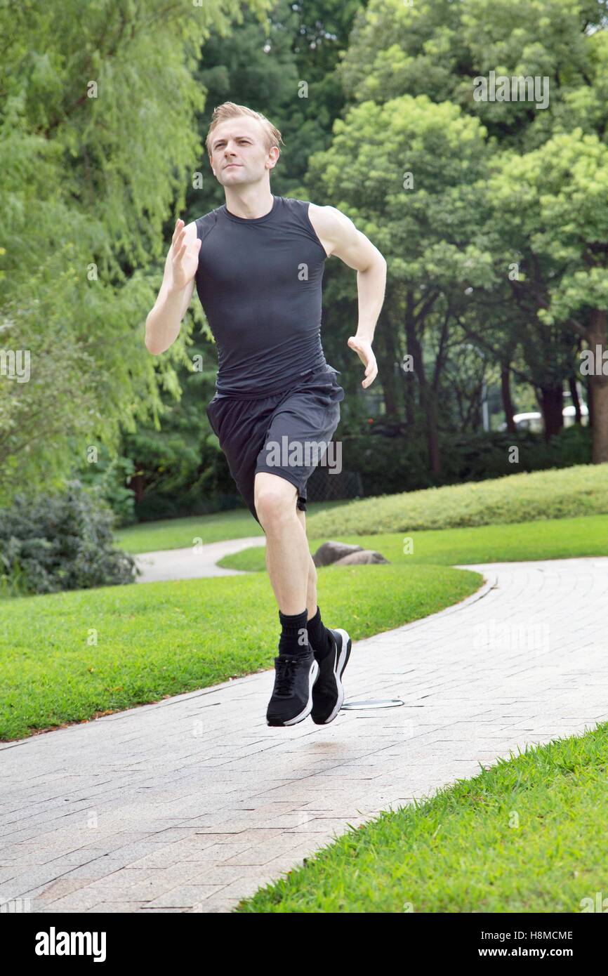 Fit and Healthy Caucasian man running in park Stock Photo - Alamy