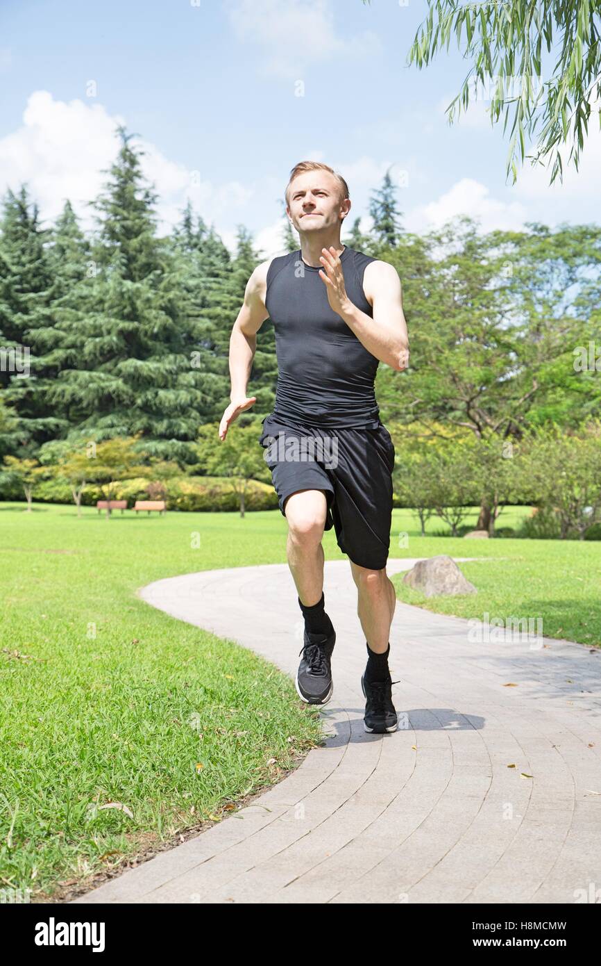 Fit and Healthy Caucasian man running in park Stock Photo - Alamy