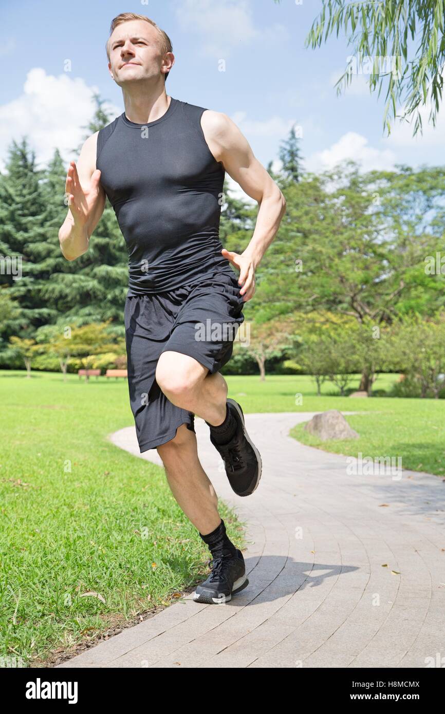 Fit and Healthy Caucasian man running in park Stock Photo - Alamy