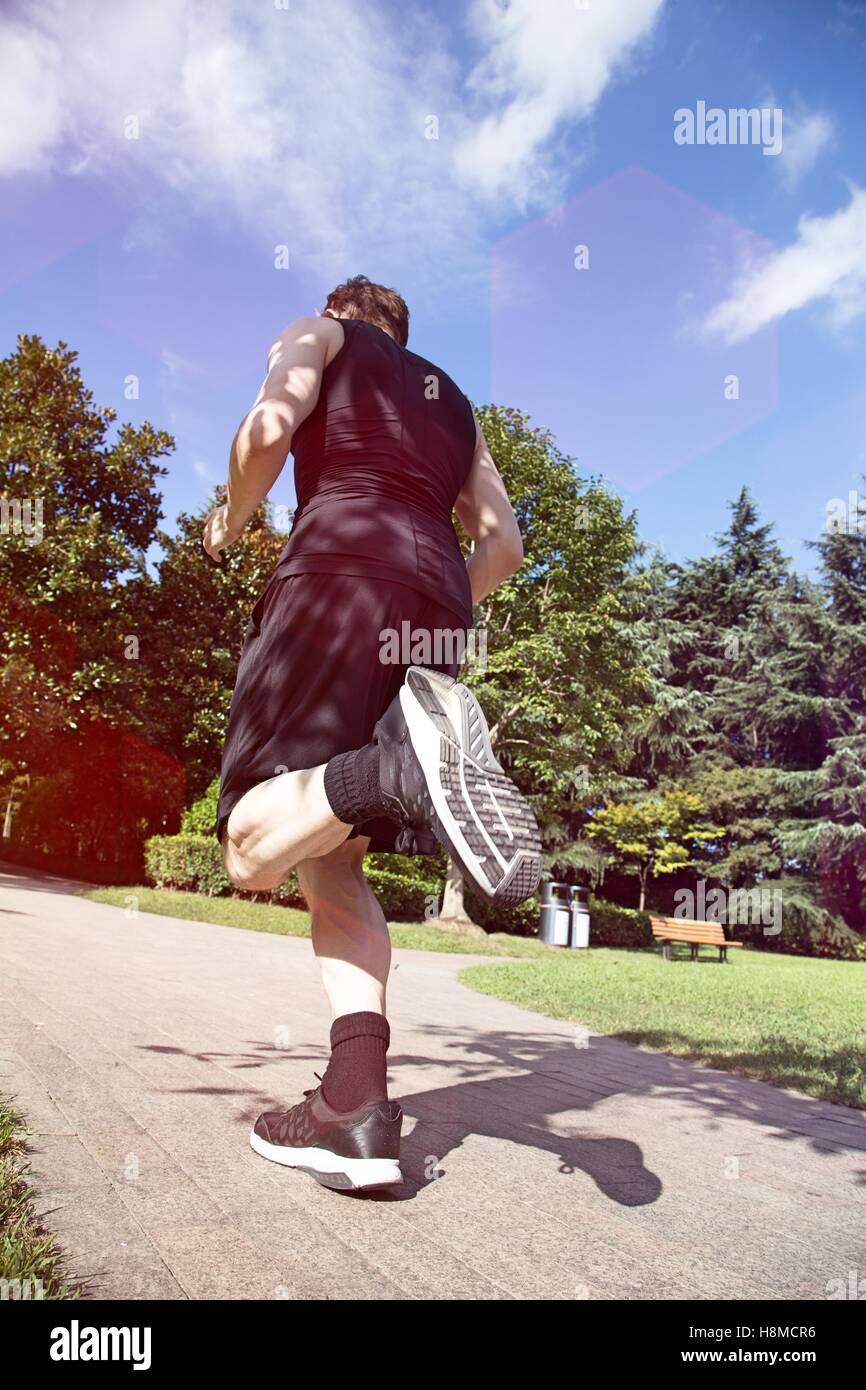 Low angle rear view of caucasian man running in park Stock Photo - Alamy