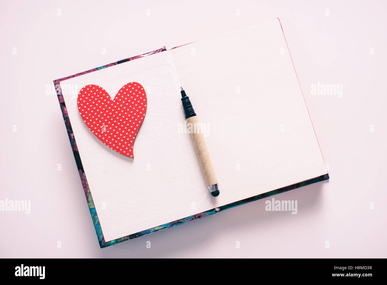 Love heart on notebook with pen Stock Photo - Alamy