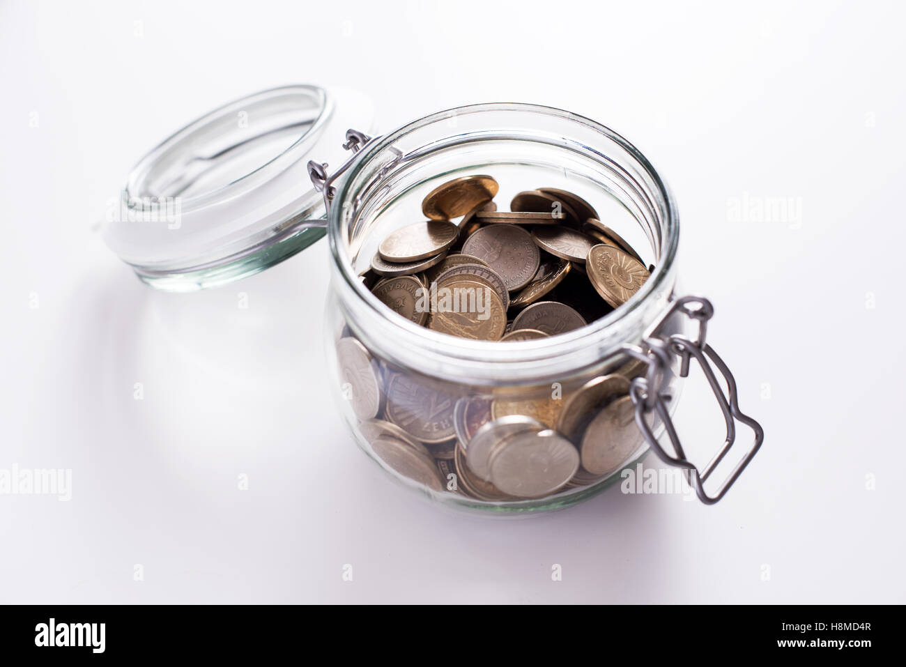 Coins in glass money jar Stock Photo - Alamy