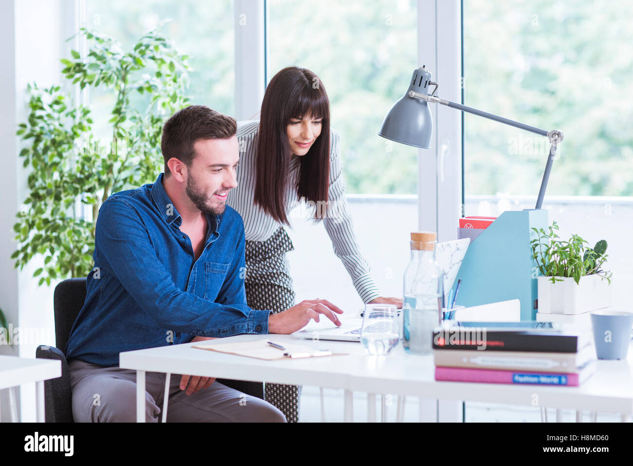 Man and Woman working in office Stock Photo - Alamy