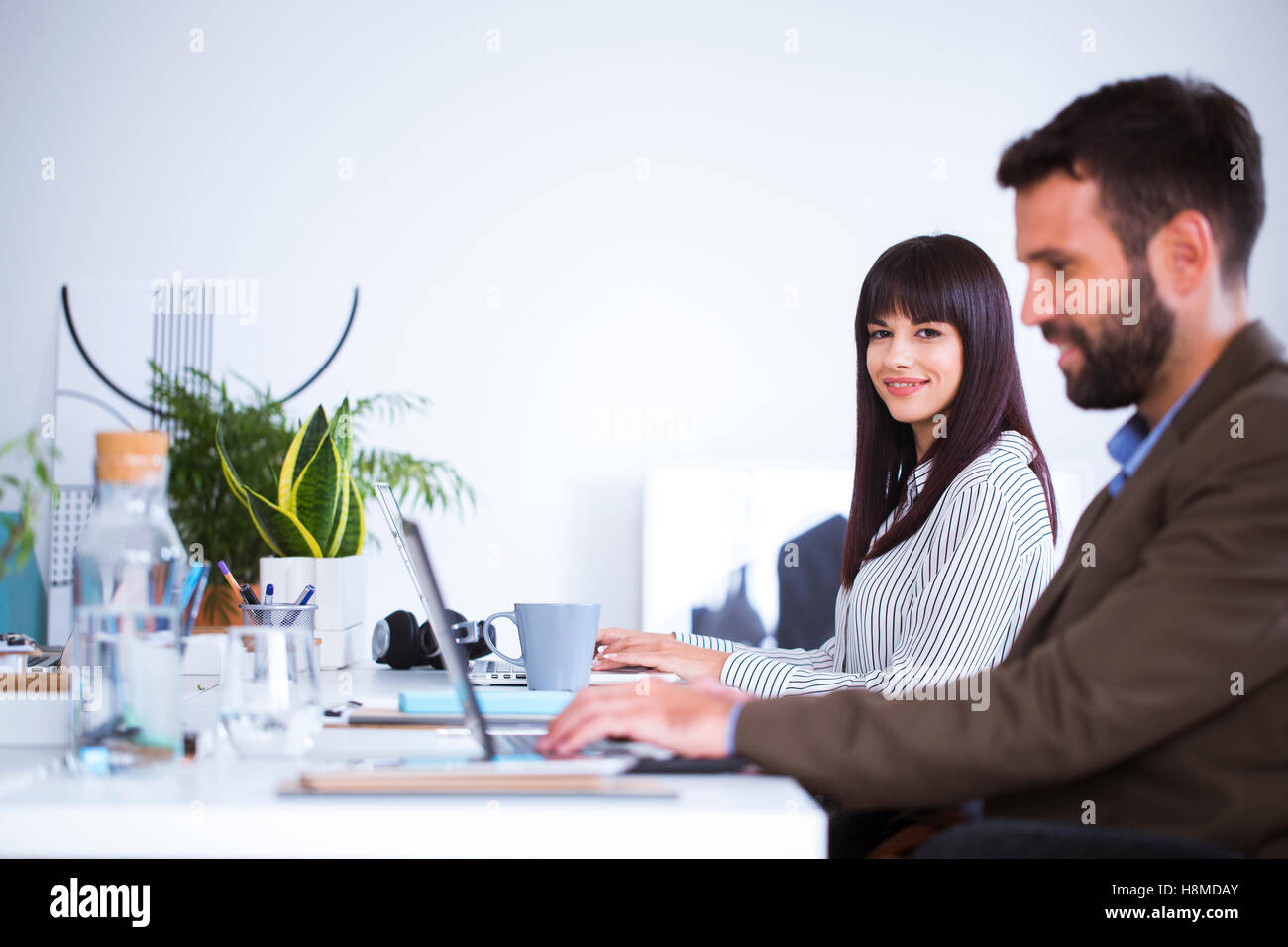 Man and Woman working in office Stock Photo - Alamy