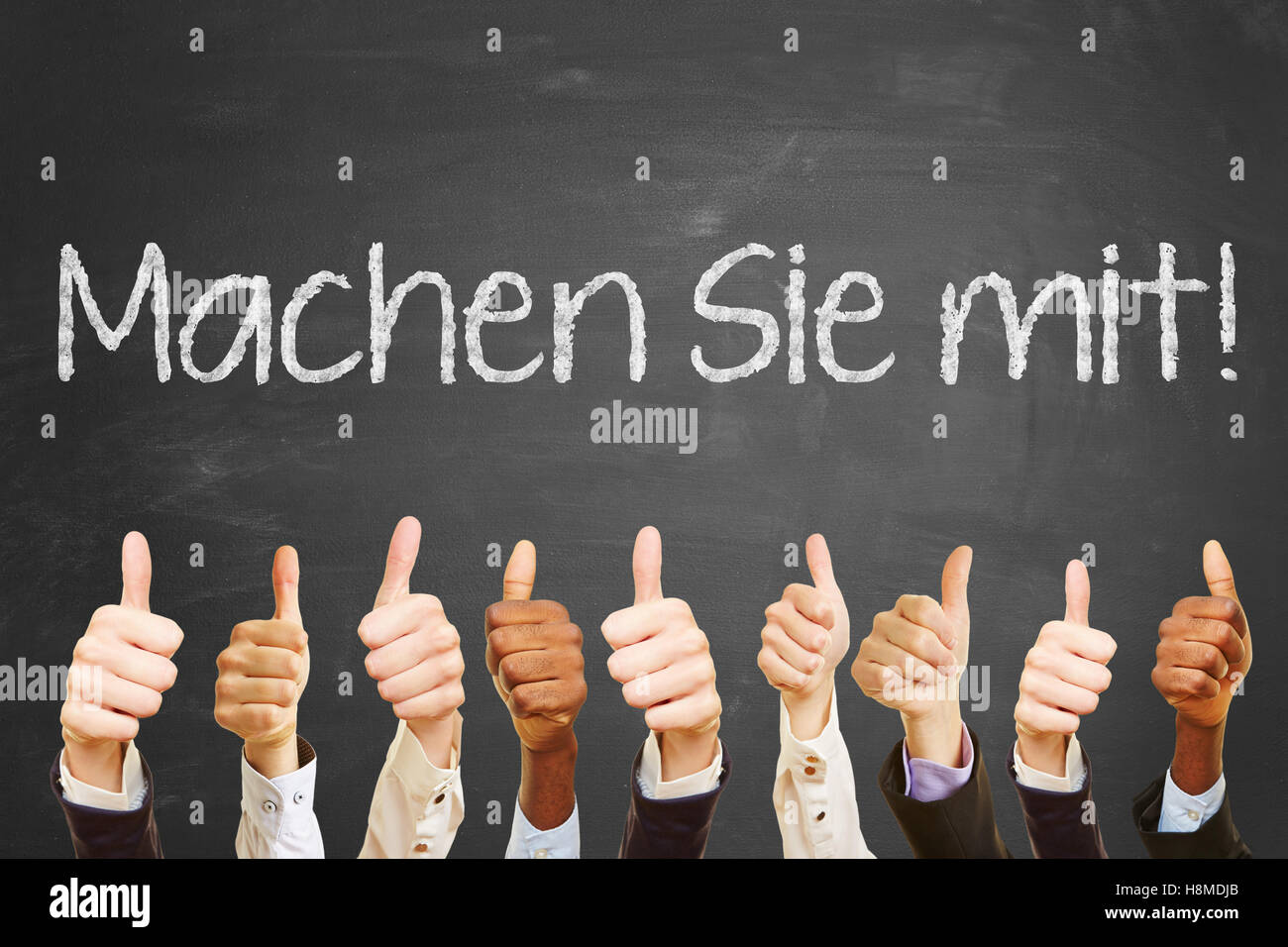 Many business hands with thumbs up as teamwork with german words ...