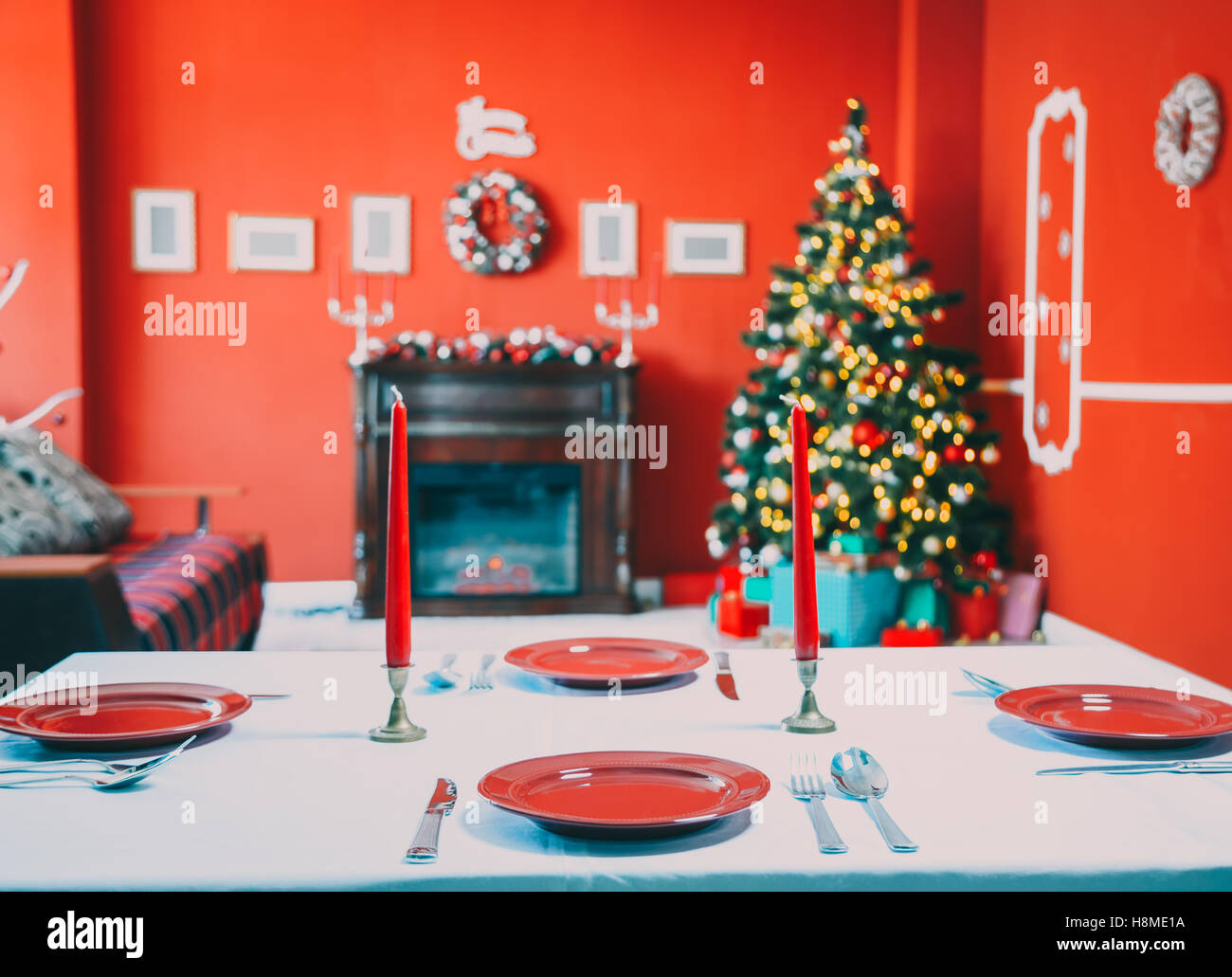 Beautifully laid new year table with red plates and Cutlery on a ...