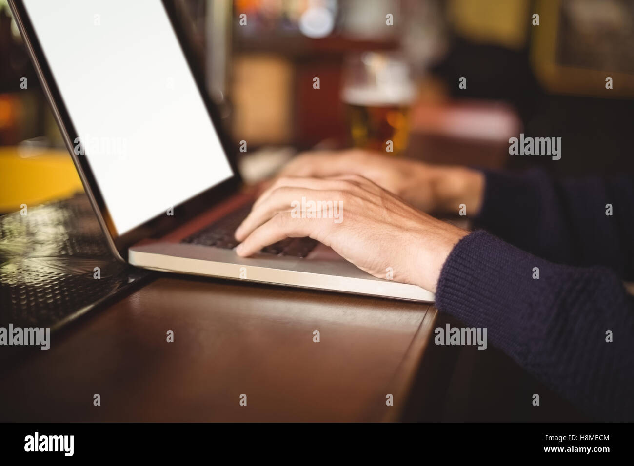 Mid section of man using laptop Stock Photo - Alamy