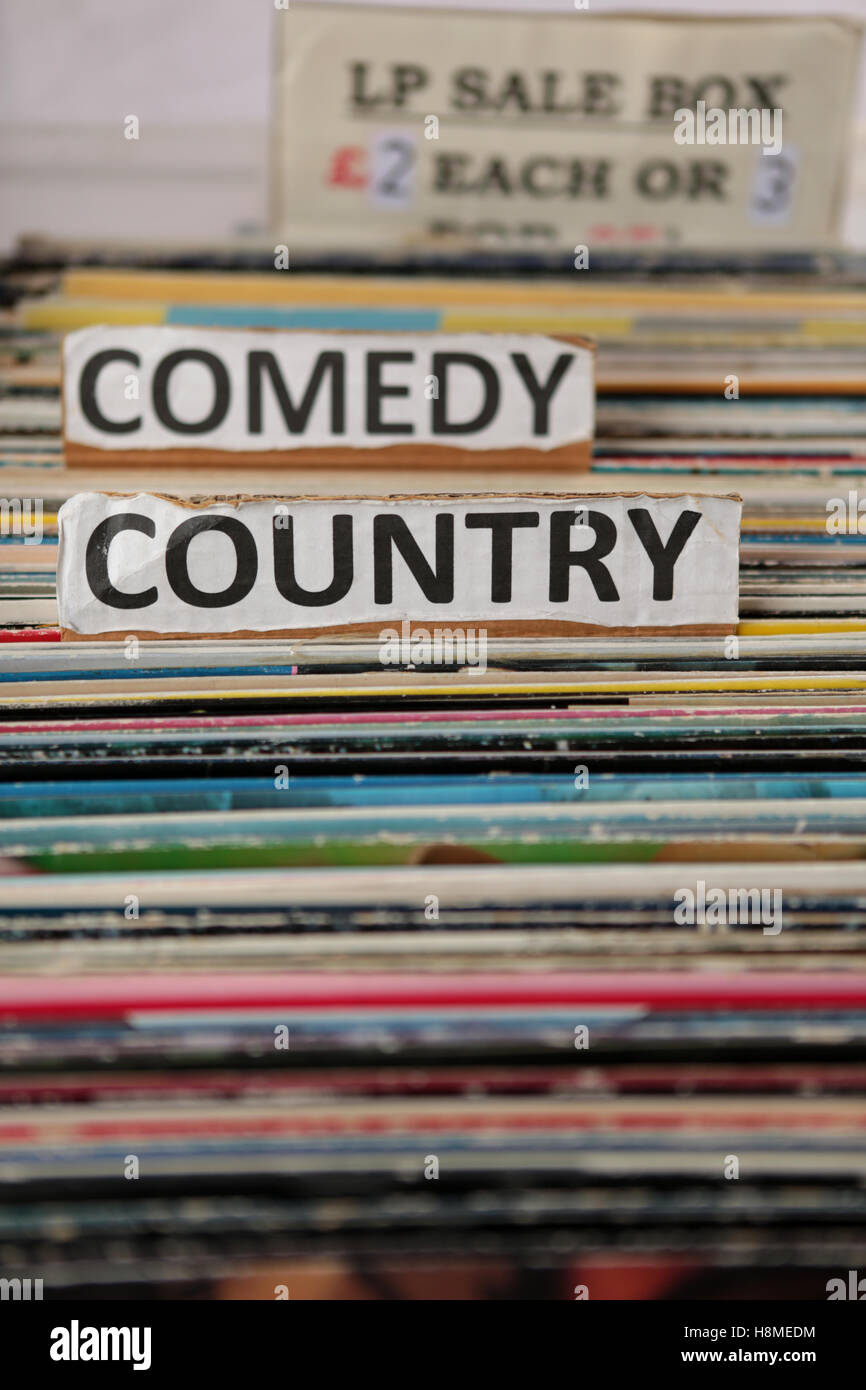 A close crop on a box of Vinyl records including tags of Comedy and ...