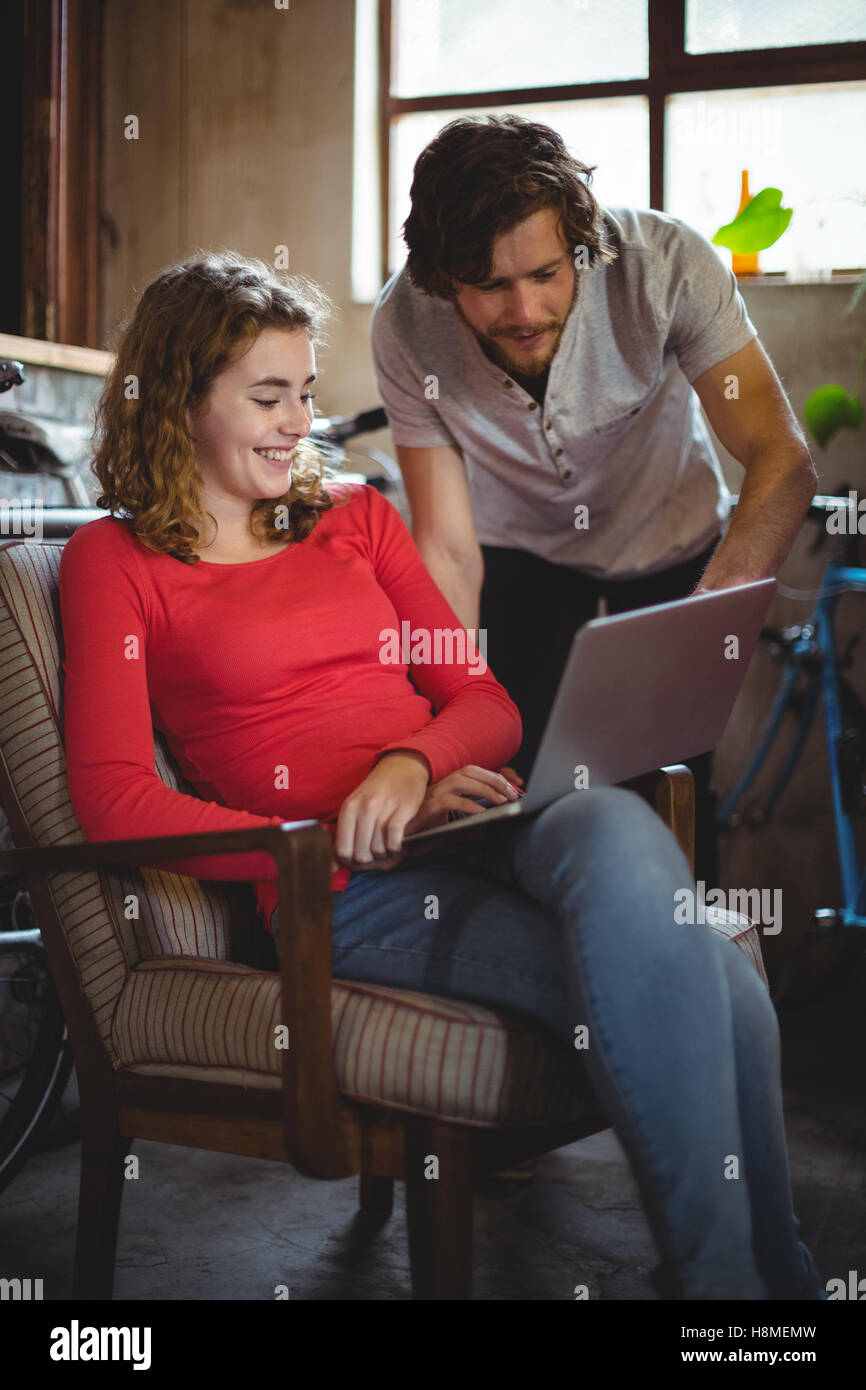 Couple using laptop Stock Photo - Alamy
