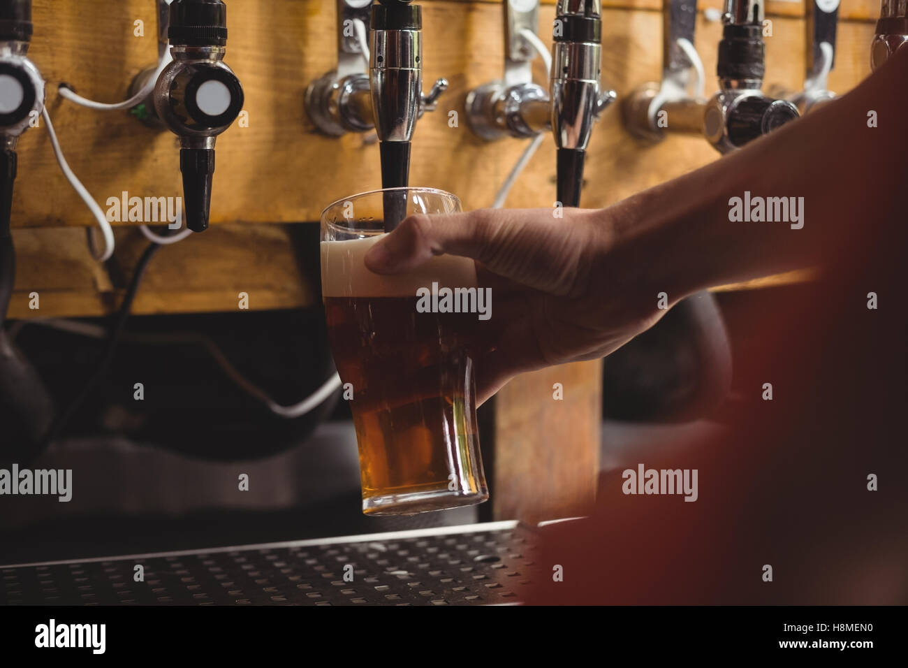 Close-up of bar tender filling beer from bar pump Stock Photo - Alamy
