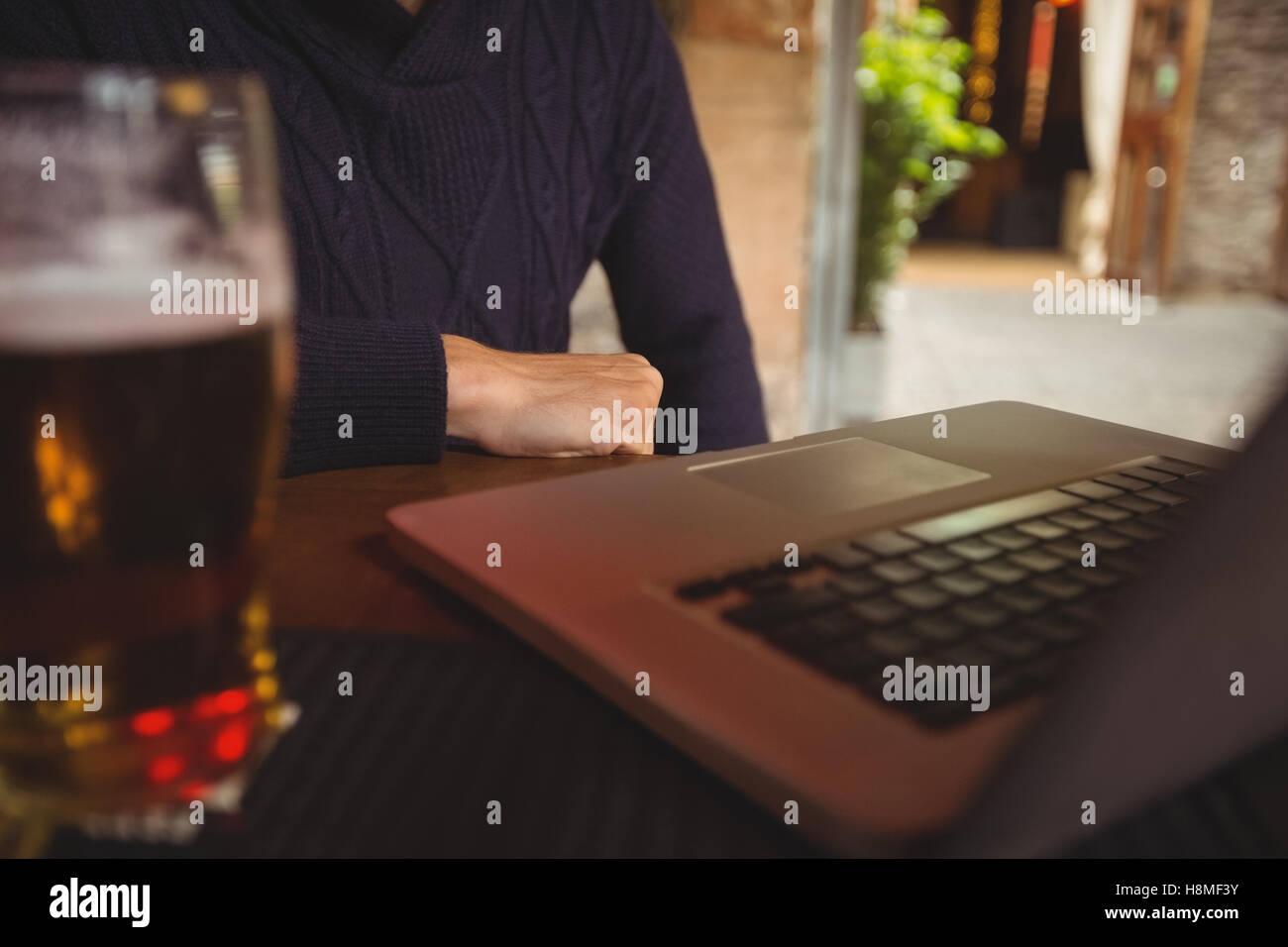 Mid section of man with laptop Stock Photo - Alamy