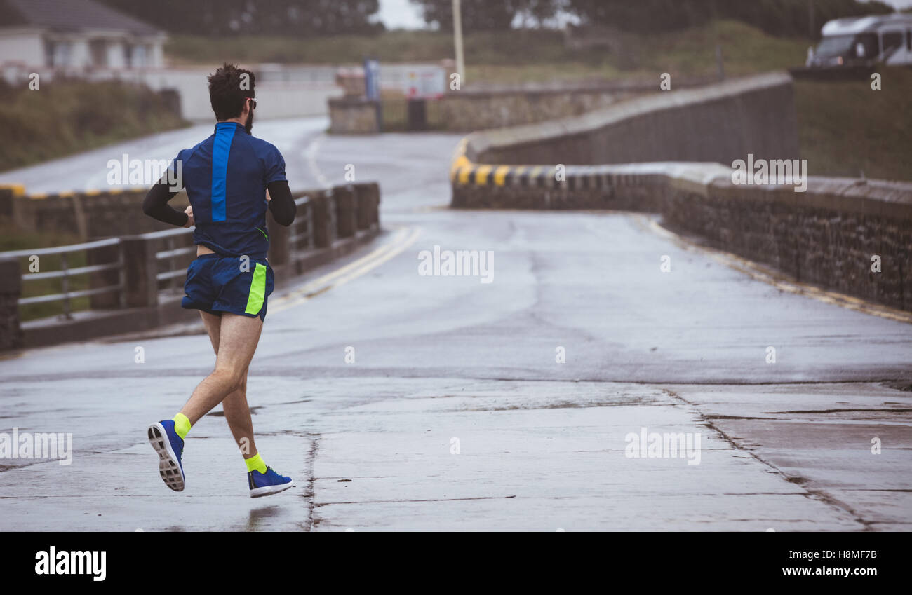 Athlete running on road Stock Photo - Alamy