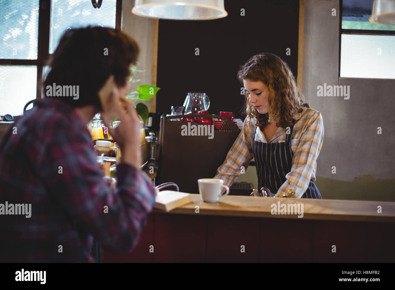 Waitress working at counter Stock Photo - Alamy