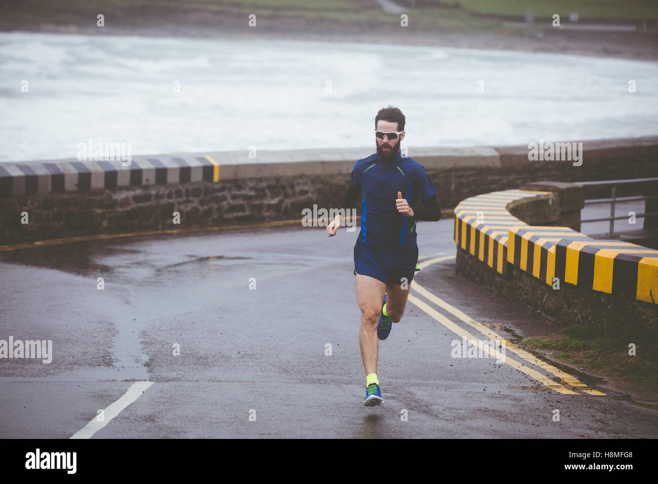 Athlete running on road Stock Photo - Alamy