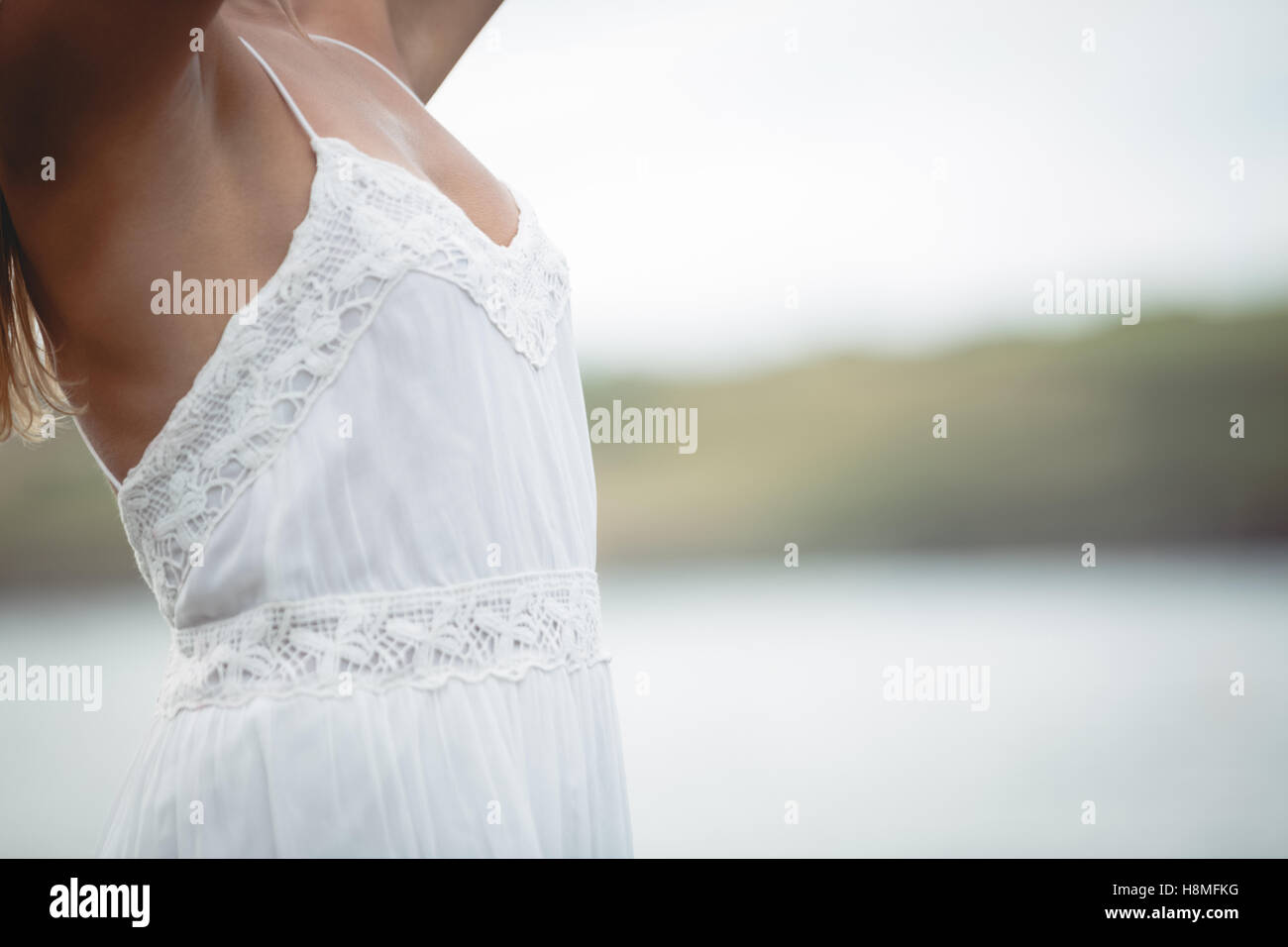 Mid section of a woman in white dress Stock Photo - Alamy