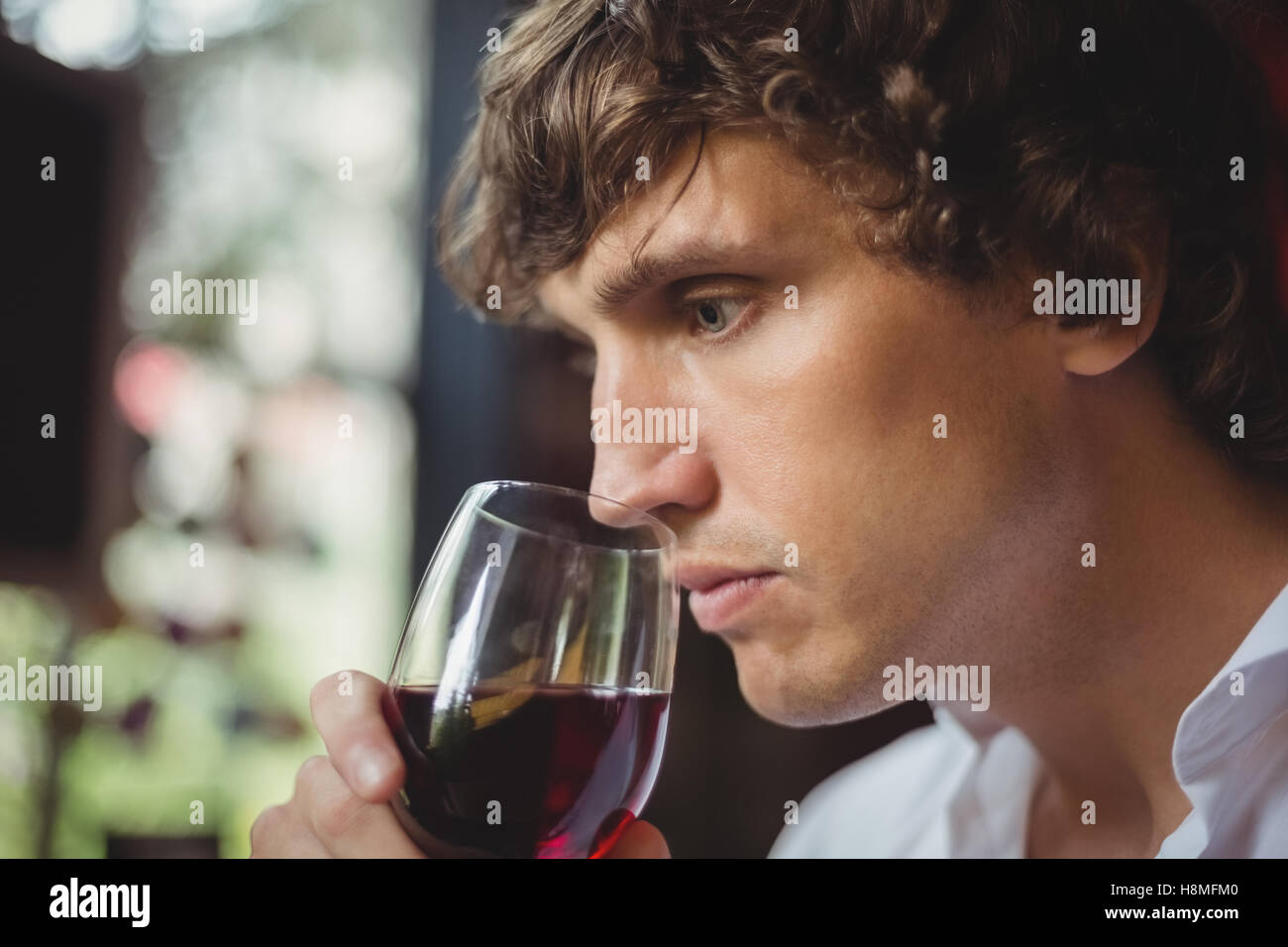 Man having a glass of red wine Stock Photo - Alamy