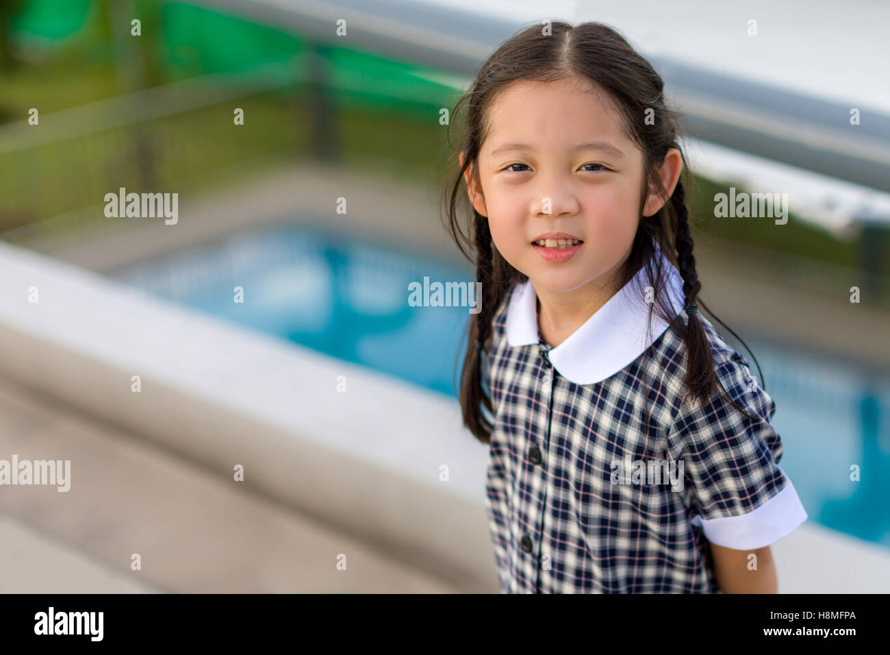 Smiling child, girl, in school uniform portrait Stock Photo - Alamy