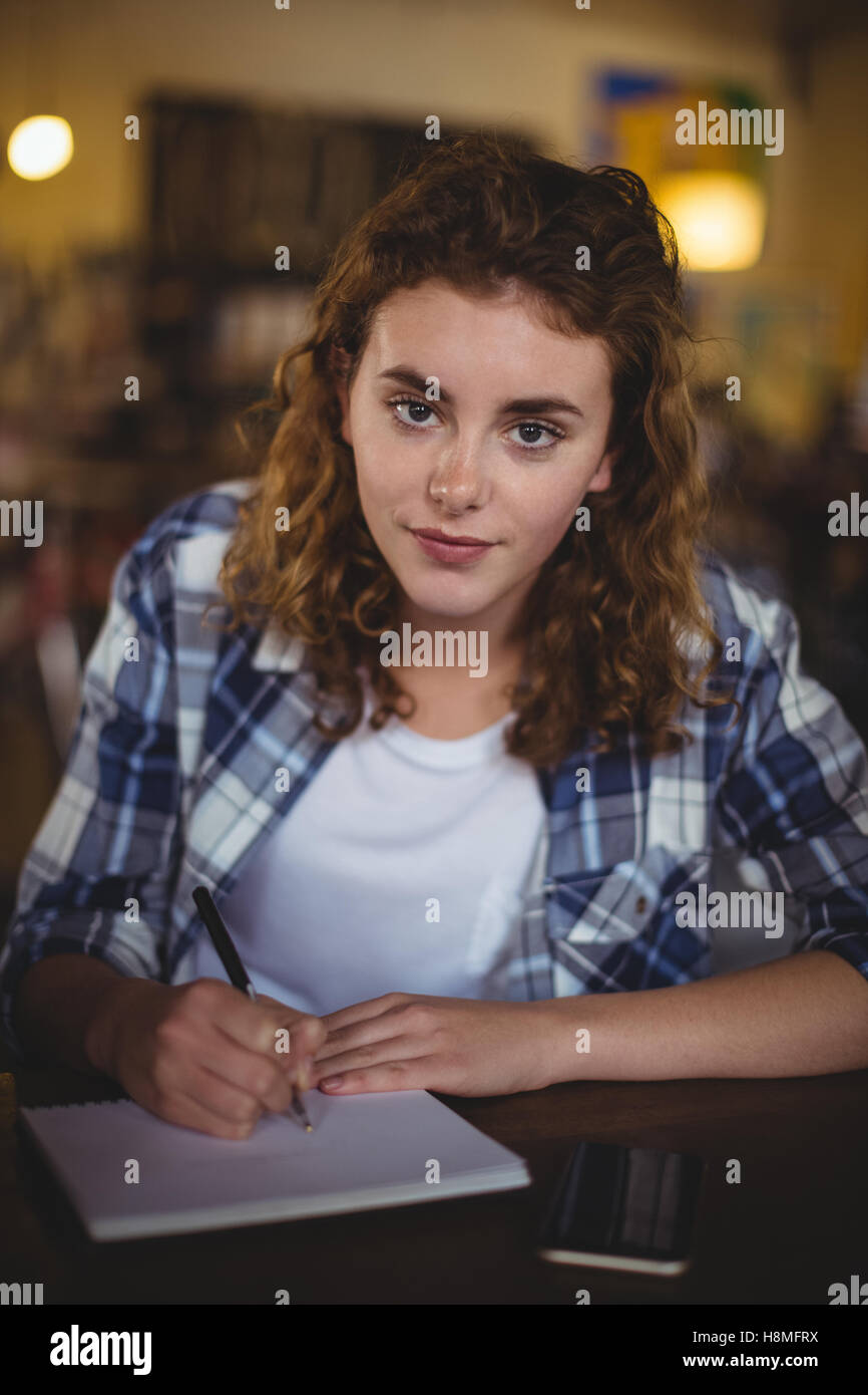 Portrait of beautiful mechanic writing in diary Stock Photo - Alamy