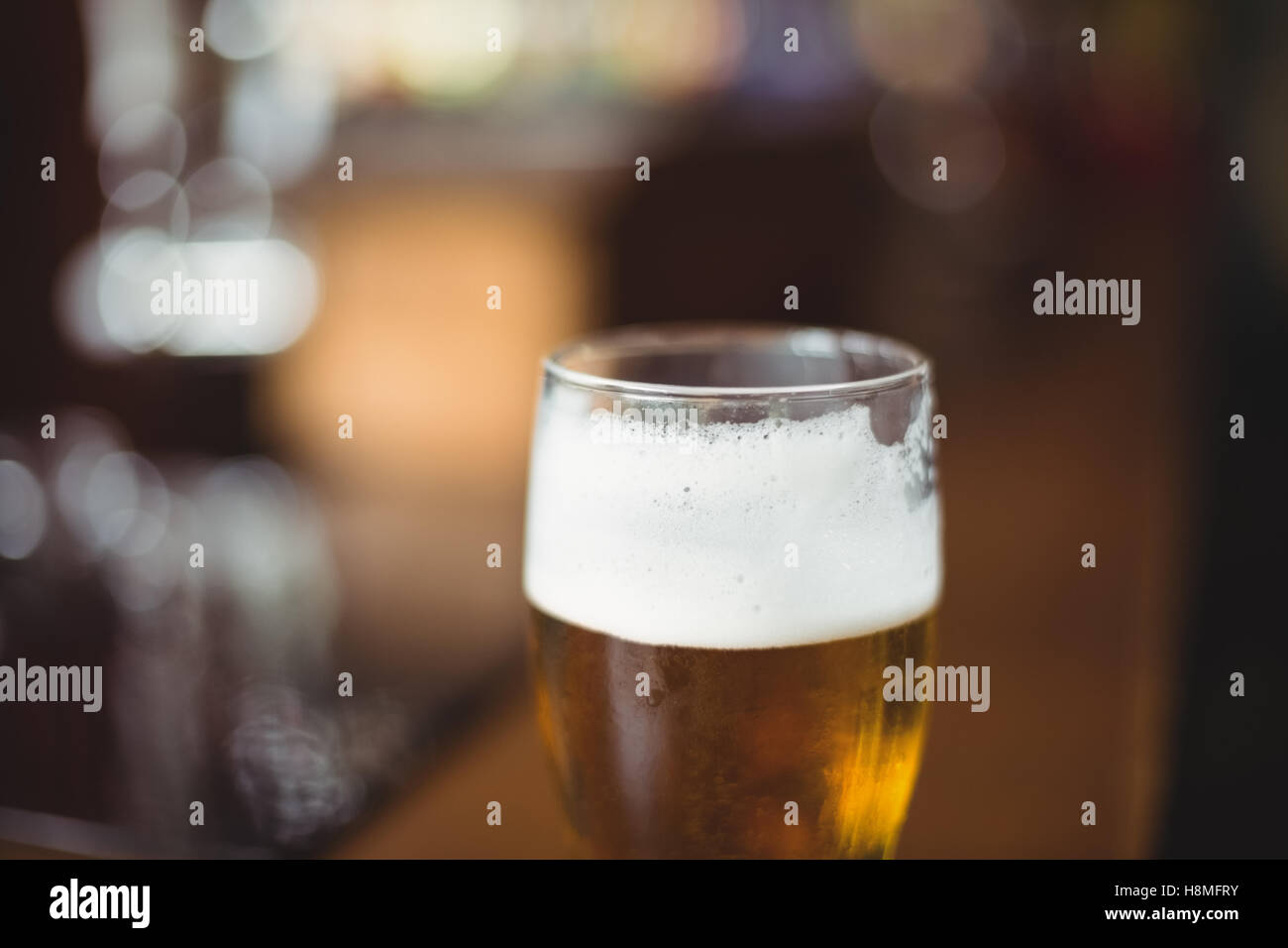 Glass of beer in bar counter Stock Photo - Alamy