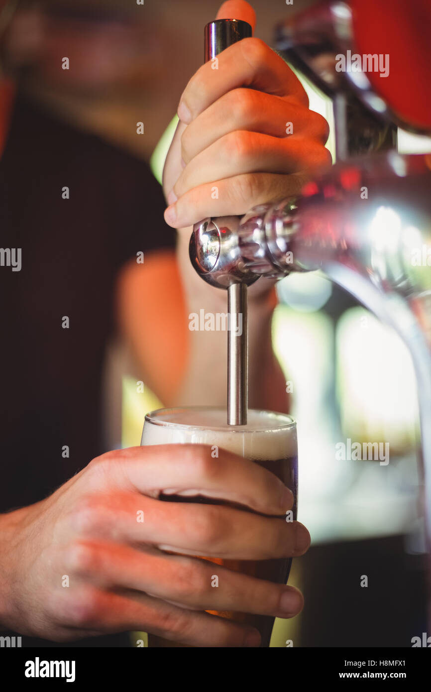 Close-up of bar tender filling beer from bar pump Stock Photo - Alamy