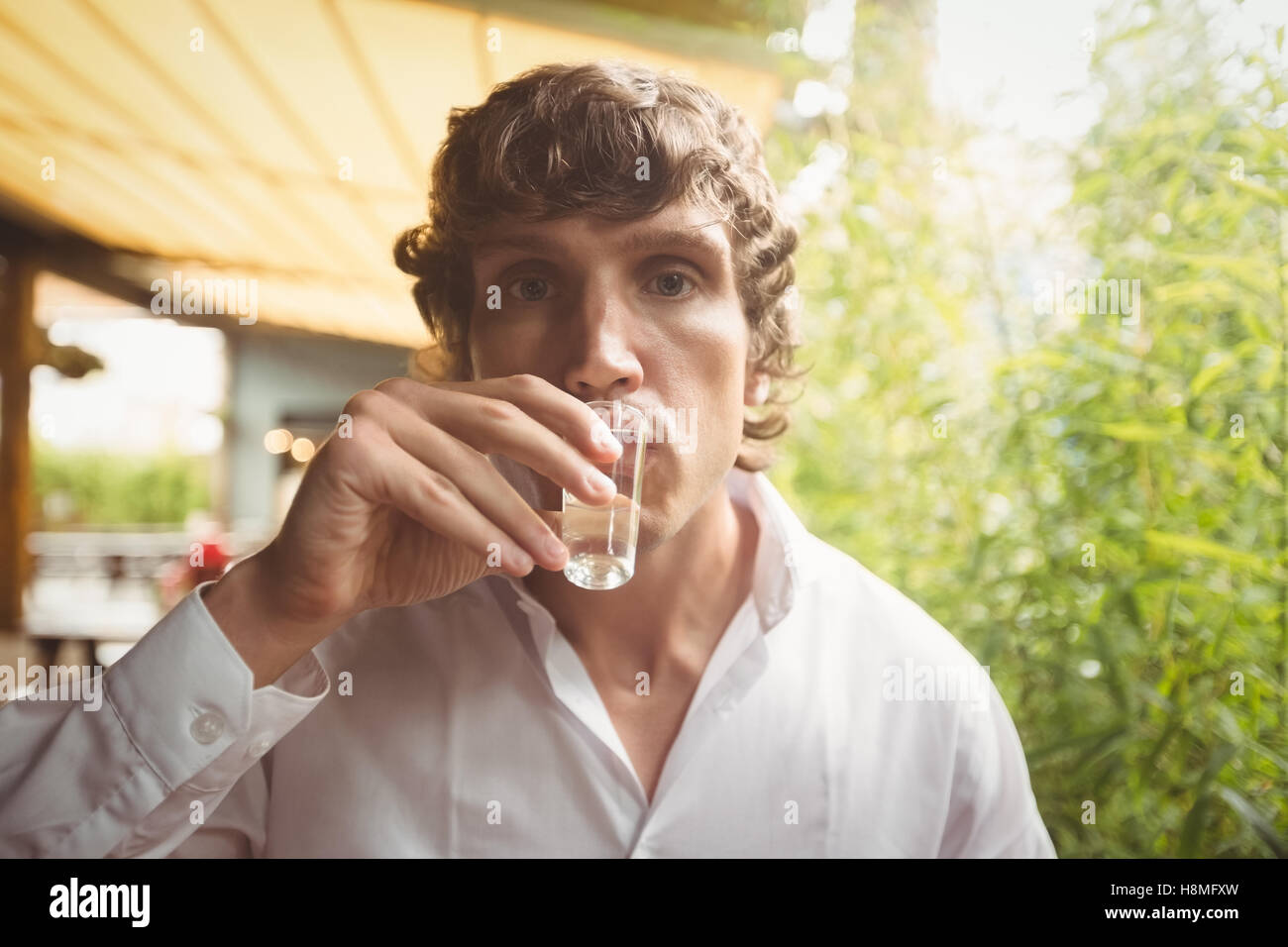 Man having tequila shot in bar Stock Photo - Alamy
