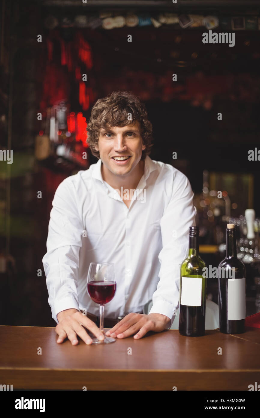 Portrait of bar tender with glass of red wine Stock Photo - Alamy