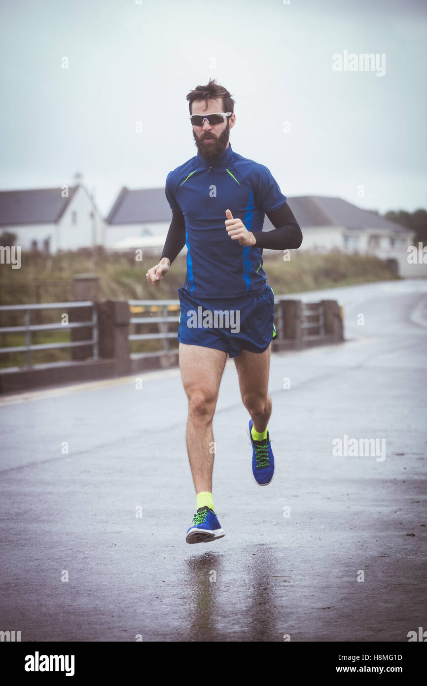 Athlete running on road Stock Photo - Alamy