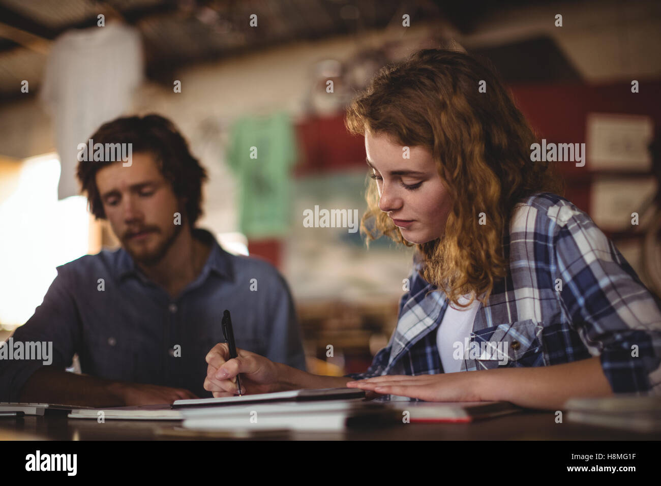 Beautiful mechanic writing in diary Stock Photo - Alamy