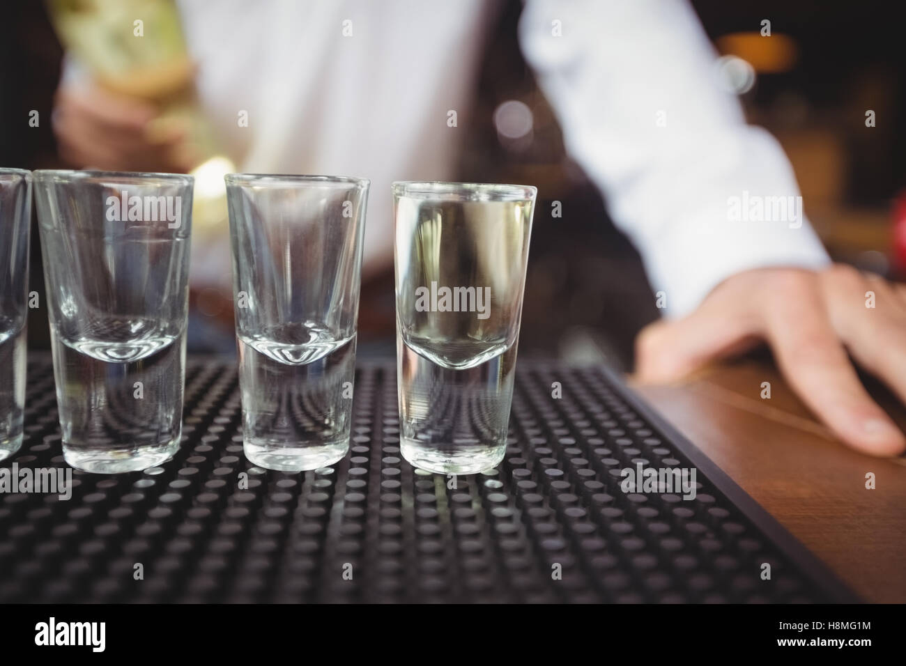 Empty shot glasses on bar counter Stock Photo - Alamy
