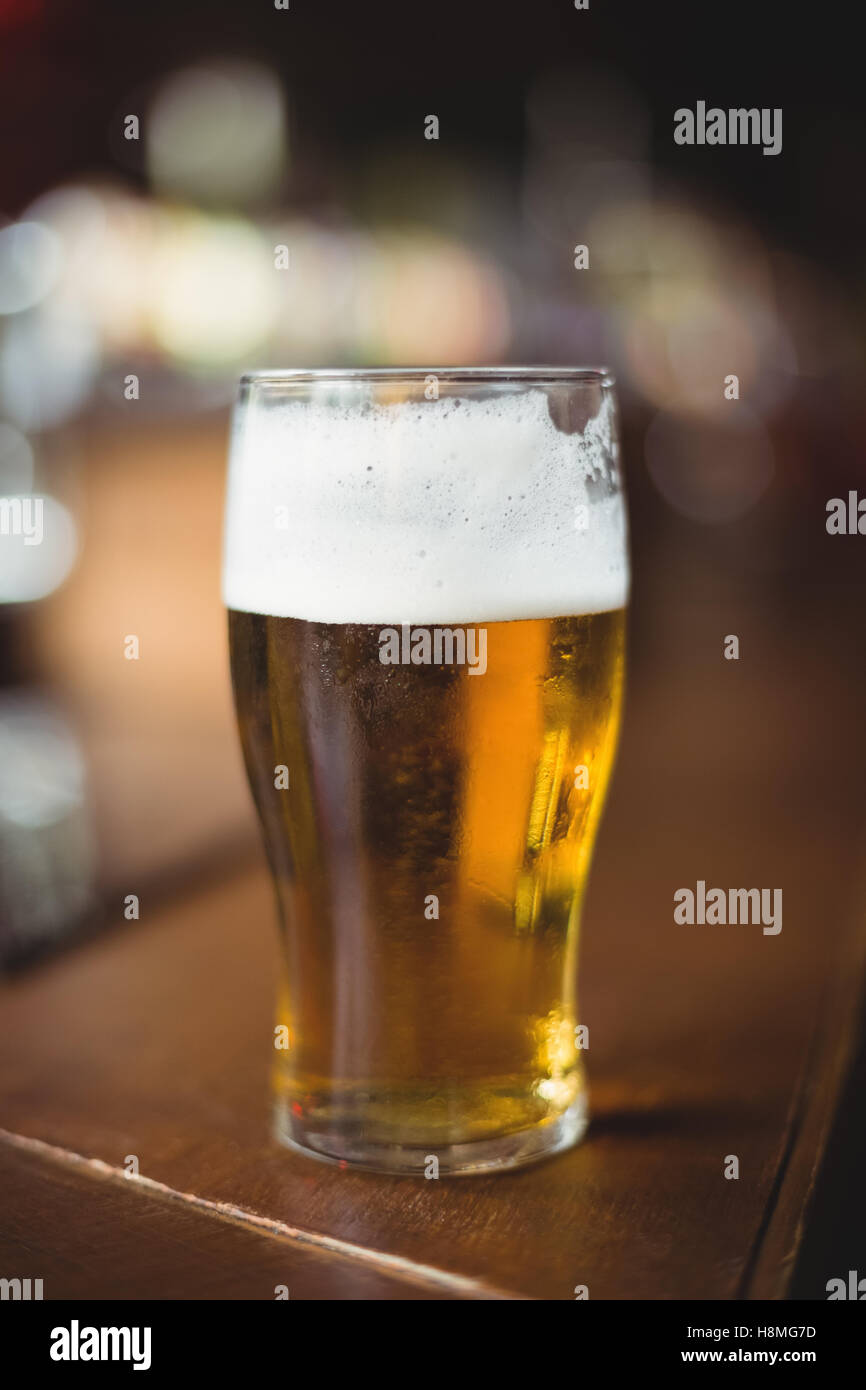 Glass of beer in bar counter Stock Photo - Alamy