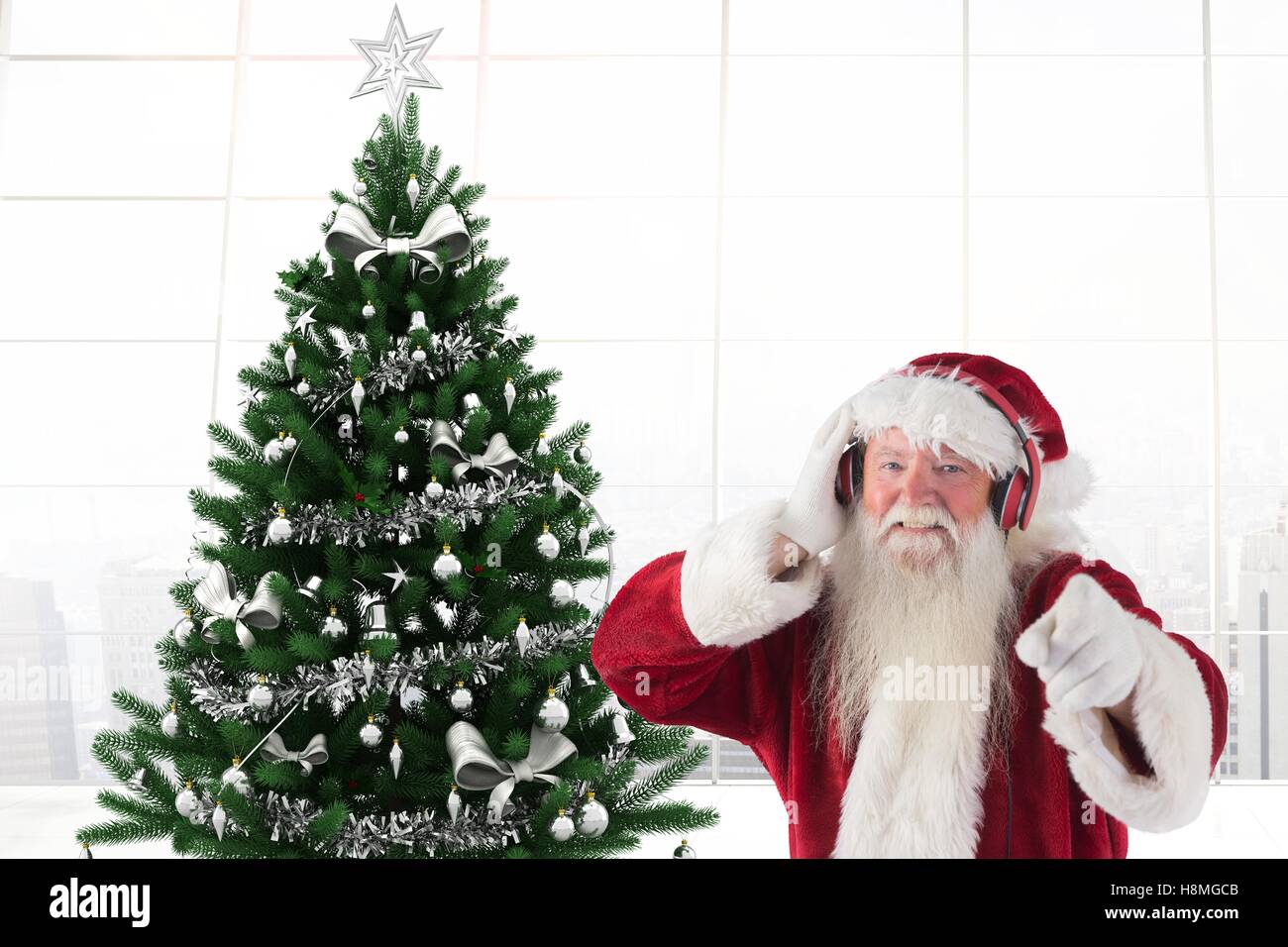 Santa claus listening to music on headphones and gesturing Stock Photo ...